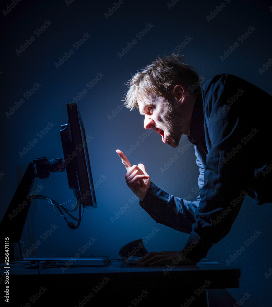 Angry Young Man pointing at at Computer Screen Stock Photo | Adobe Stock
