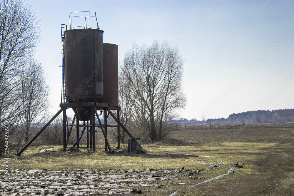 Iron towers for water on the field. Water storage tanks. Stock Photo ...
