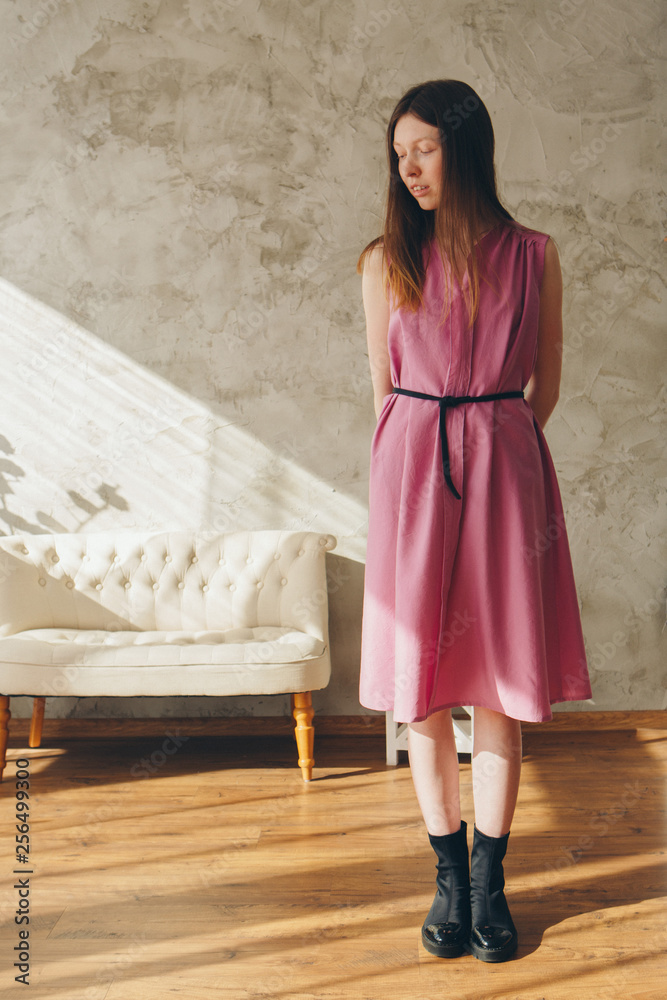 Beautiful girl without makeup in pink dress with black belt on home ...