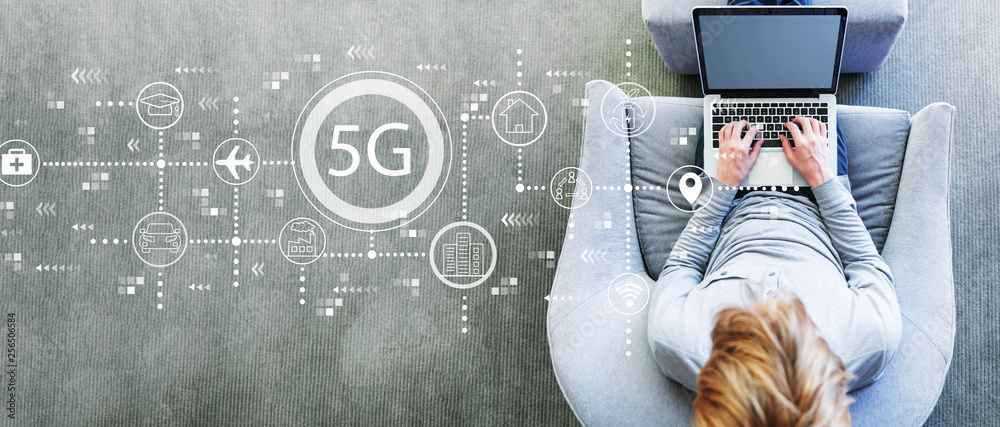 5G network with man using a laptop in a modern gray chair Stock Photo ...