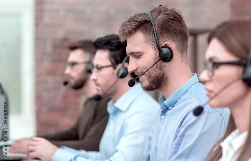 side view.the call center operator and her colleagues work in the ...