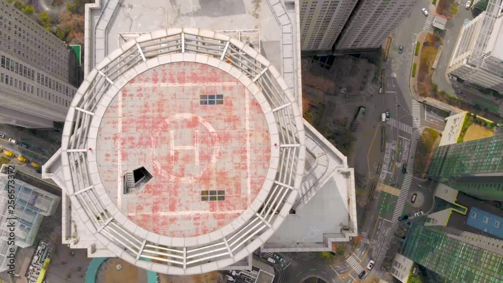 Bird's eye view of a vibrant Helipad and then a slow pan up to the vast ...