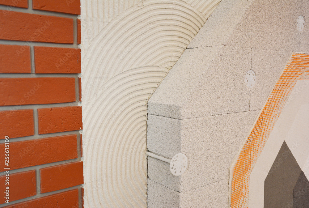 House brick wall renovation, insualtion with glue plastering layers ...