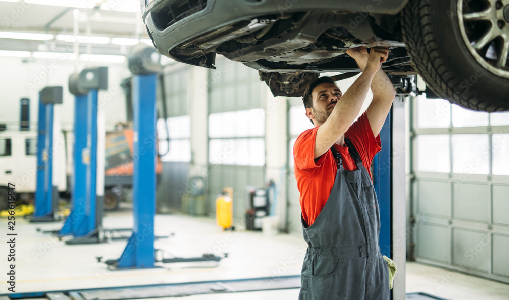 Car mechanic working at automotive service center Stock Photo | Adobe Stock