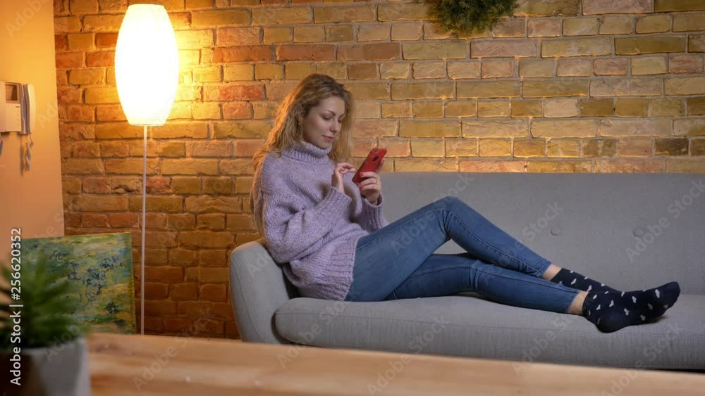 Closeup shoot of adult caucasian blonde female using the phone while ...