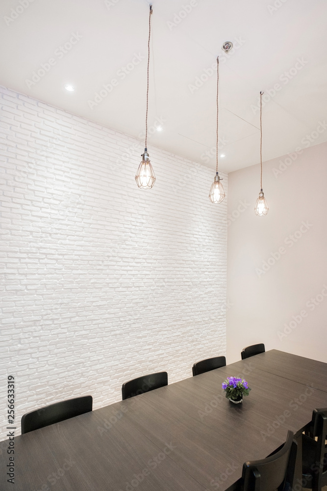 White room with vintage downlight hanging from ceiling, brick white ...