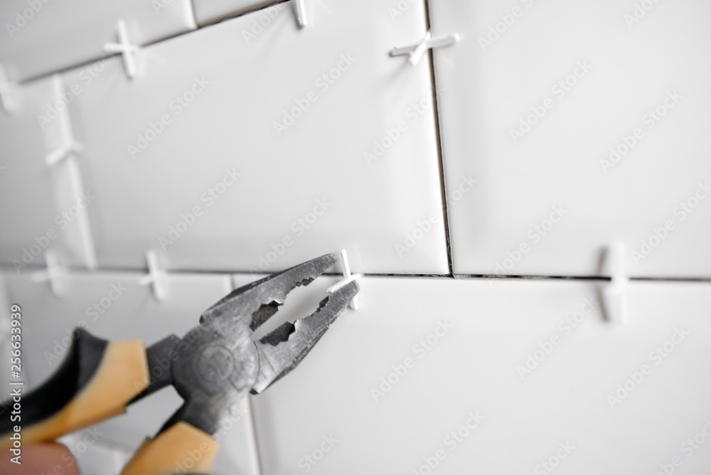 Ceramic tile lying. Installing new subway or metro tiles in bathroom ...