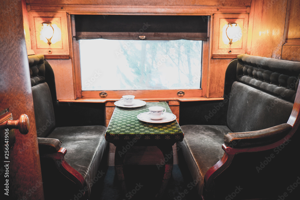 Travelling inside a luxurious vintage train carriage, private room with ...