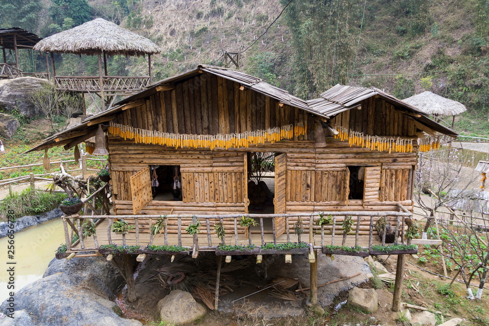 Traditional Hmong ethnic minority stilt house with garland of corn ...