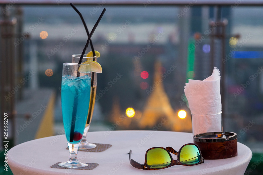 Cocktails on roof terrace in Yangon, Myanmar, with Sule Pagoda in soft ...