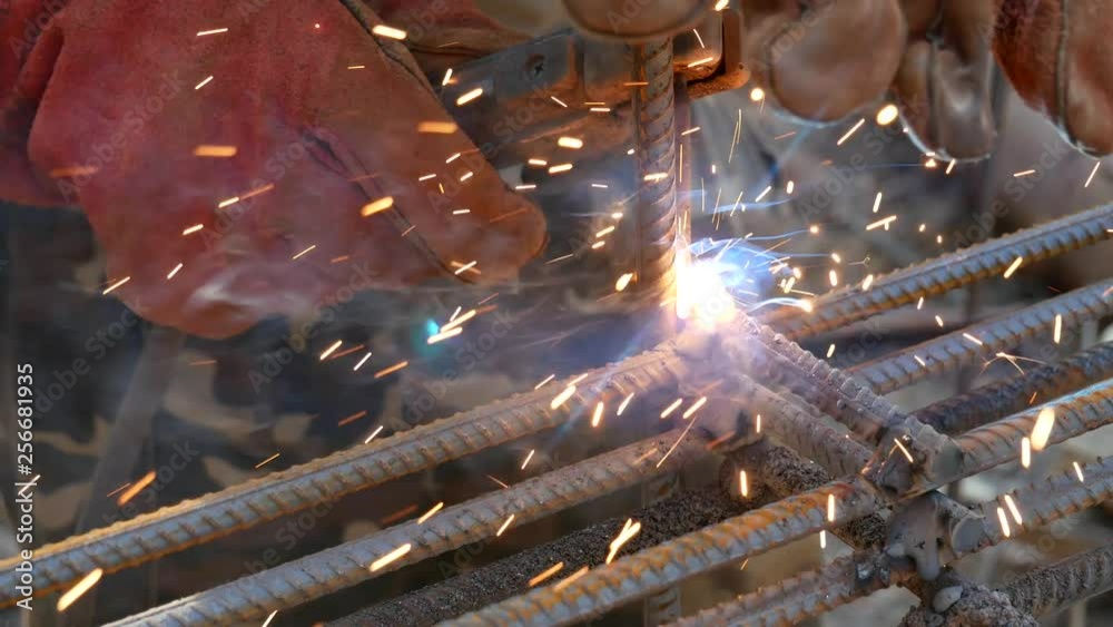 Electrode welds metal. Hand welder in mittens with electrode holder ...