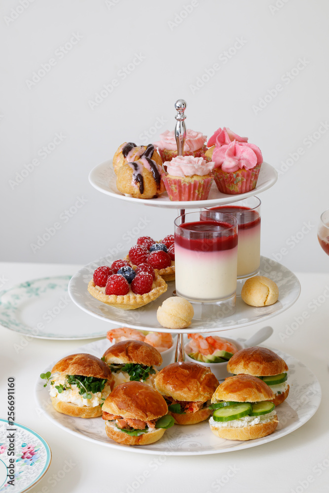 Afternoon tea with mini brioche canapes and selection of sweets Stock ...