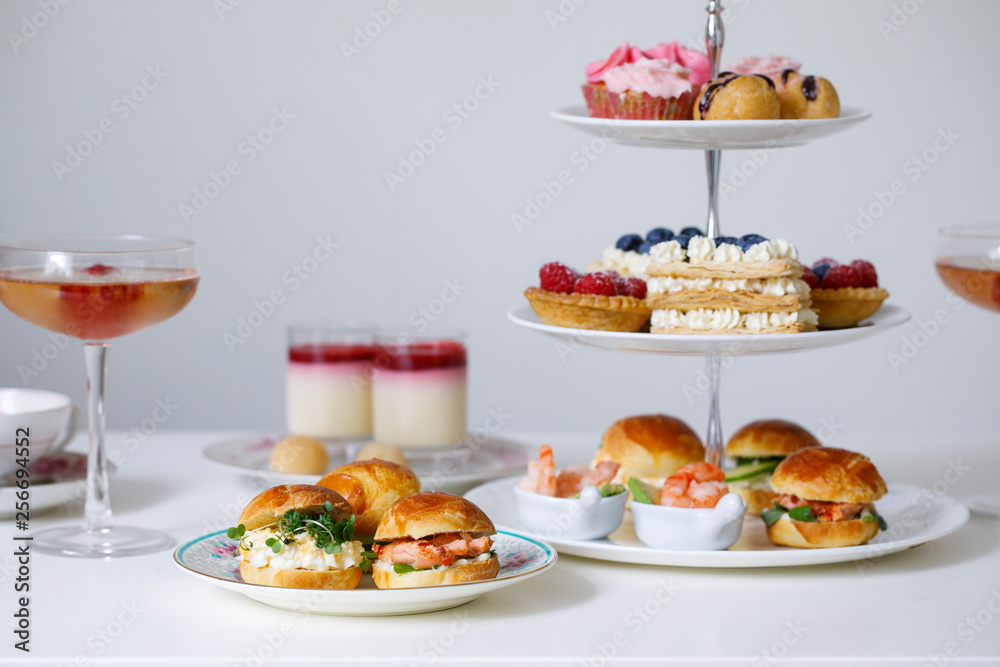 Afternoon tea with mini brioche canapes and selection of sweets Stock ...