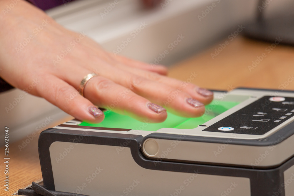 The process of scanning fingerprints during the check at border ...