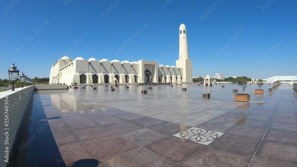 Scenic Doha Grand Mosque with a minaret at sun light reflecting on the ...