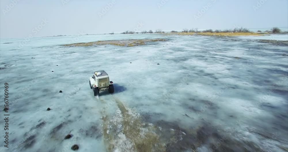 Zooming in aerial view of swamp buggy driving on wonderful blue but ...