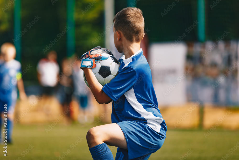 Young Soccer Goalie Goalkeeper Catching Ball. Young Boy Soccer Goalie ...
