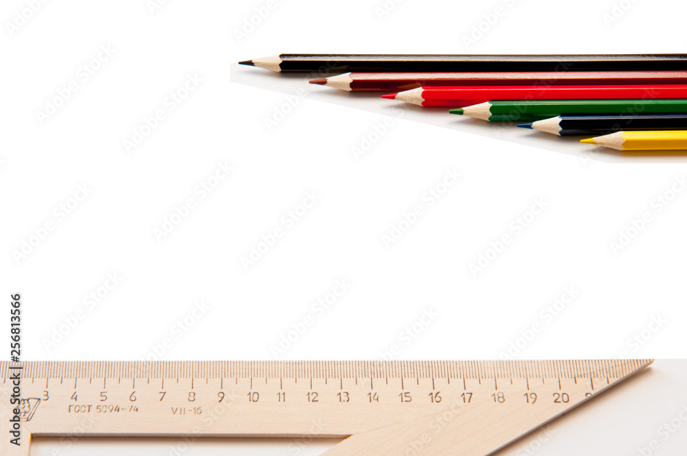 Colored pencils and wooden ruler on white background. Several different ...