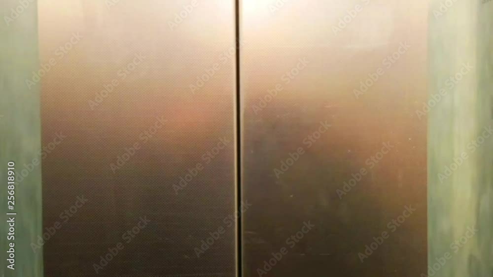 Closed silver lift doors showing the floors as we passed through the ...