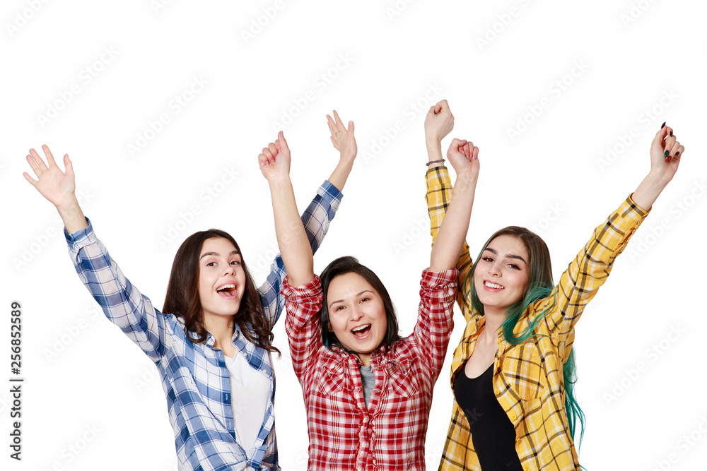 three beautiful young girls with their hands up happily. isolated on ...