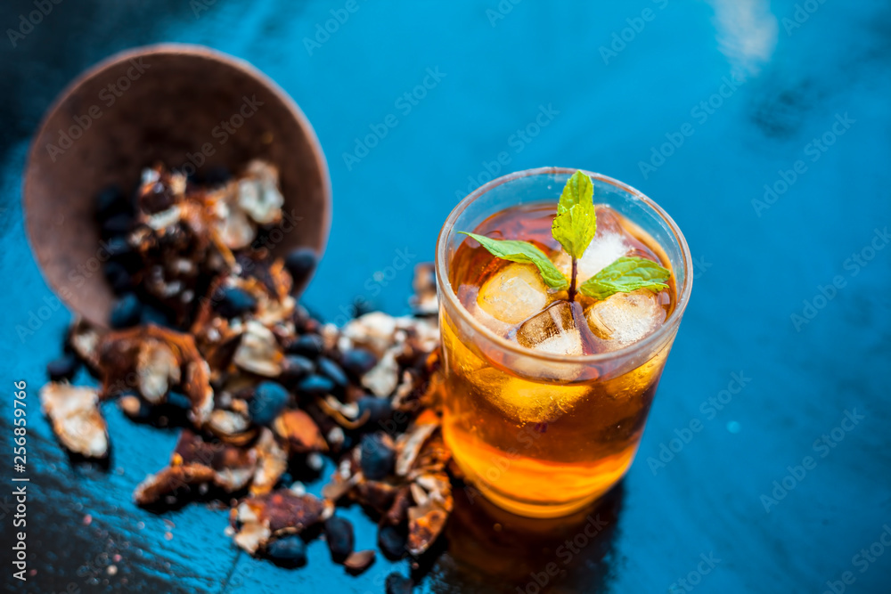 Tamarind or imli or amli in a clay bowl along with its roasted seeds ...
