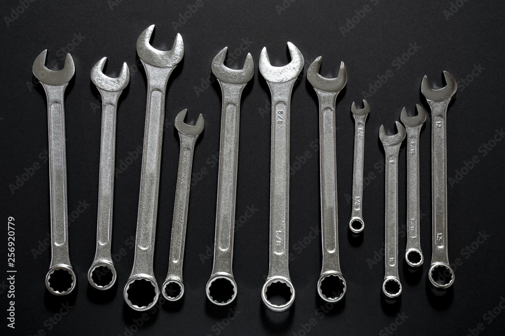 Spanner Set. Silver coloured spanners lying side by side in black ...