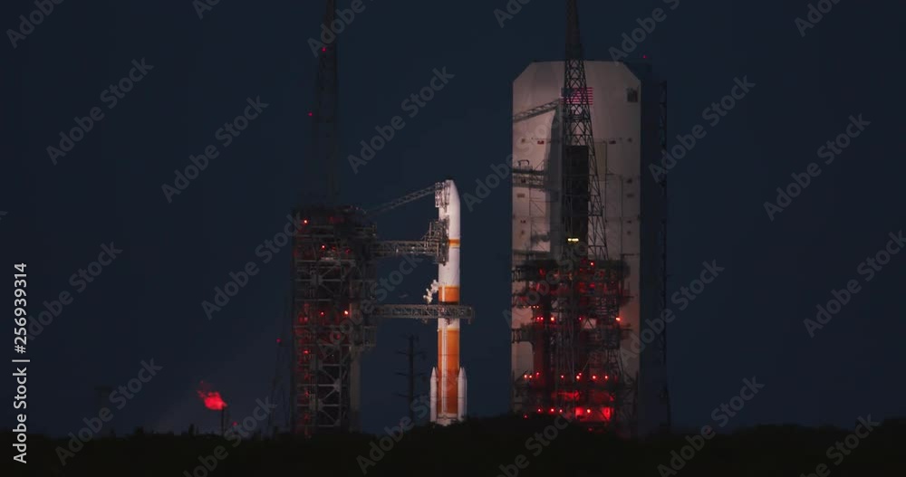 A space rocket sits on the launch pad at dusk as is prepares to launch ...
