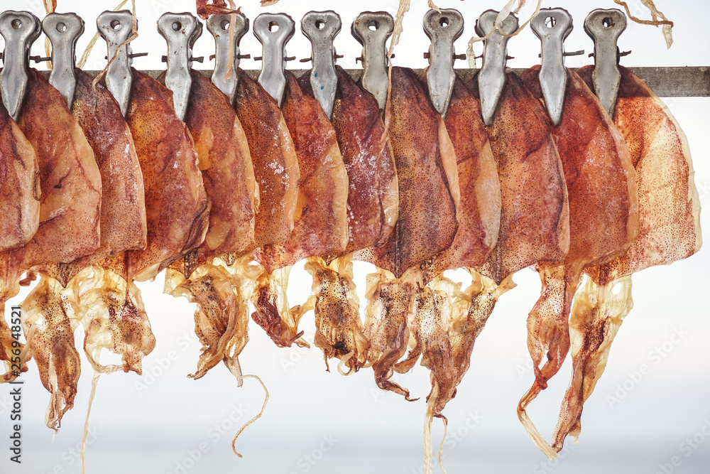 Sun dried squid row on cart. Squids dry on the beach. Traditional ...
