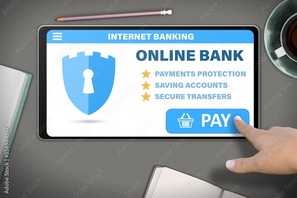 hand with tablet pc tapping button pay on modern table background ...