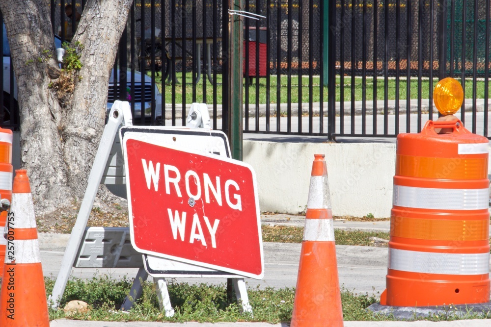 Orange traffic cones and Wrong Way Sign,Red background with white ...