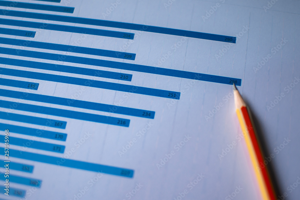 Many charts and graphs with magnifying glass and many pencil ...