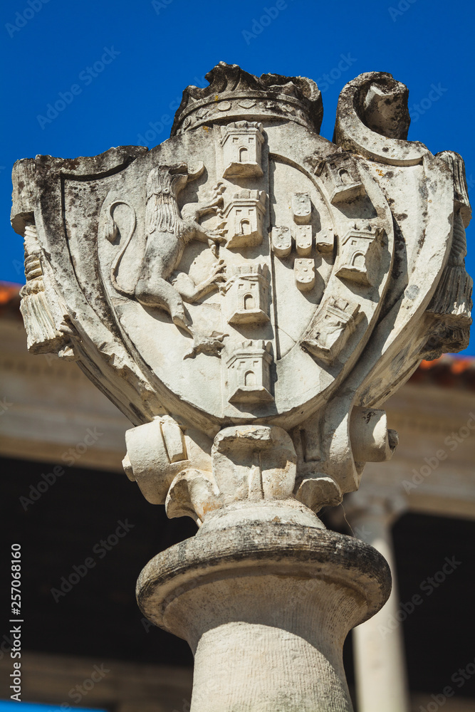 medieval emblem in stone in palace of bishop of Coimbra, Portugal Stock ...