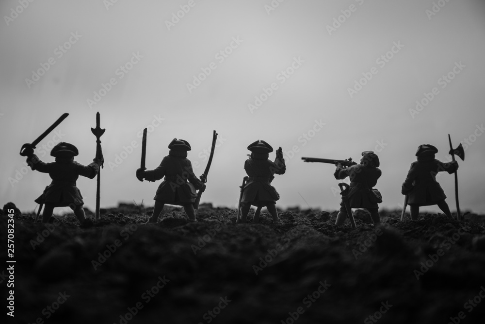 The musketeer in a black broad-brimmed hat fires an old brown musket ...