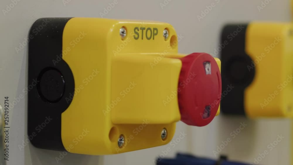 Palm pressing red stop button, hand reset emergency signal. Stopping ...