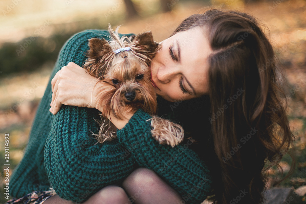 Beautiful woman hugging with dog in the park Stock Photo | Adobe Stock