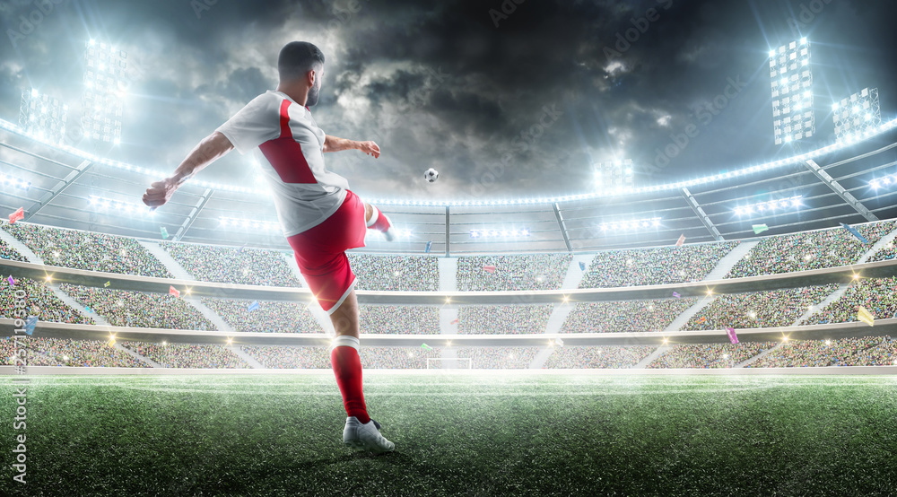 Soccer action. Professional soccer player kicks a ball on the night ...