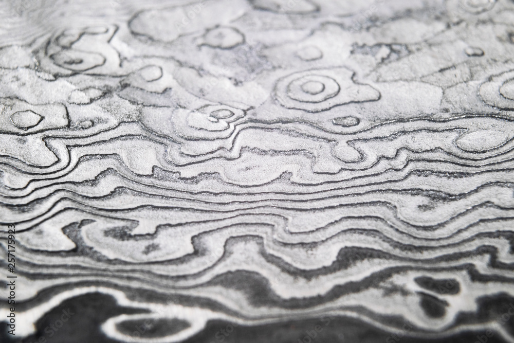 Background with pattern of damask steel. Close up. Macro shot of a ...