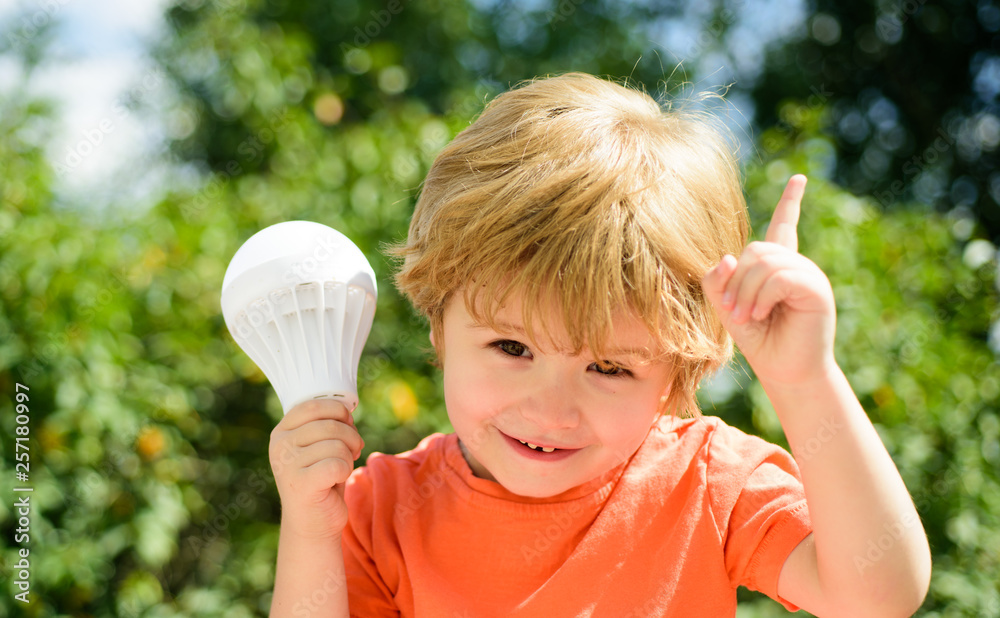 Little cute school boy and electric bulb. Smart kid having a bright ...