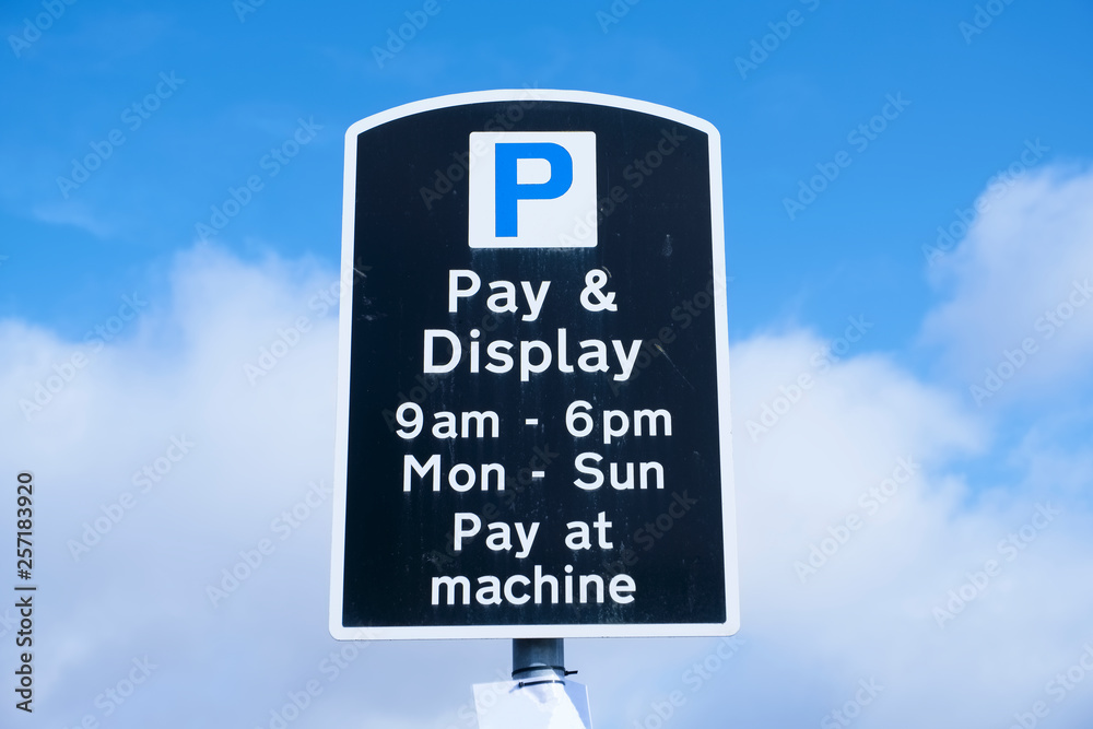 Pay and display payment coins at machine sign in sky Stock Photo ...