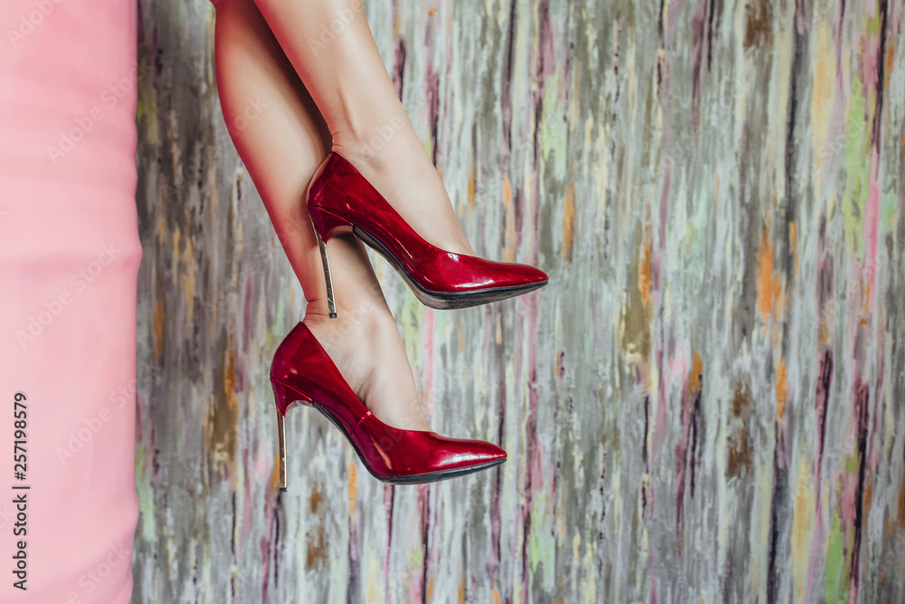 Beautiful female legs with red heels isolated on studio summer ...