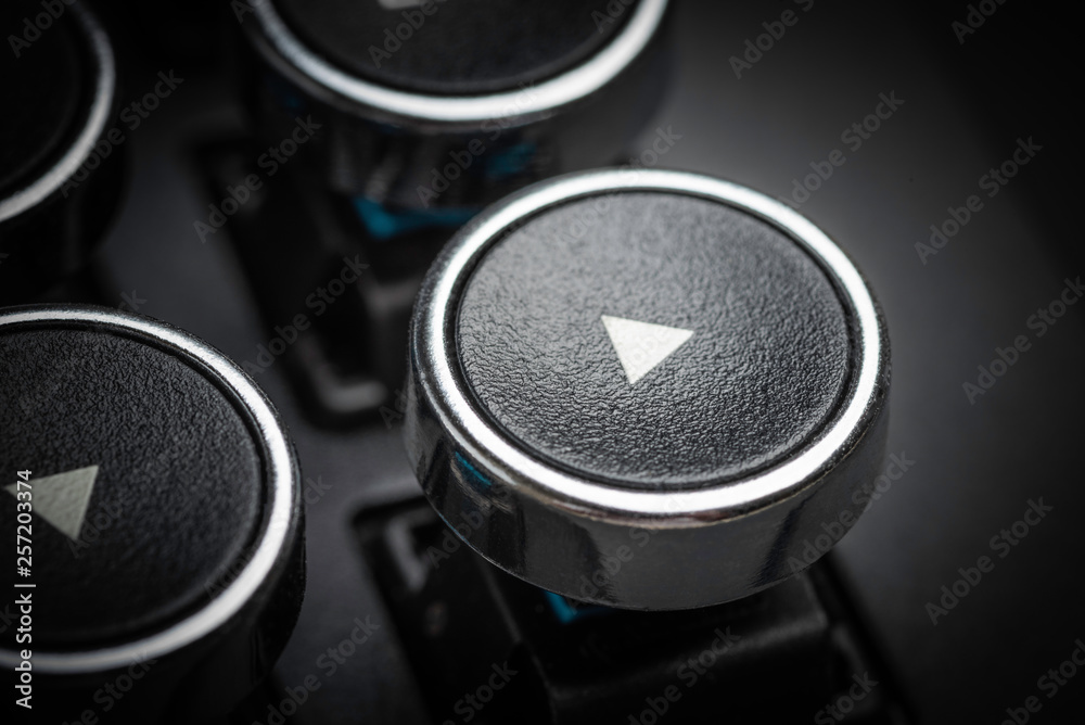 An extreme close-up or macro shot of a round directional arrow key on a ...