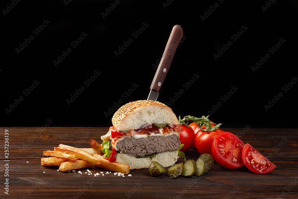Homemade hamburger cut in half close-up with beef, tomato, lettuce ...