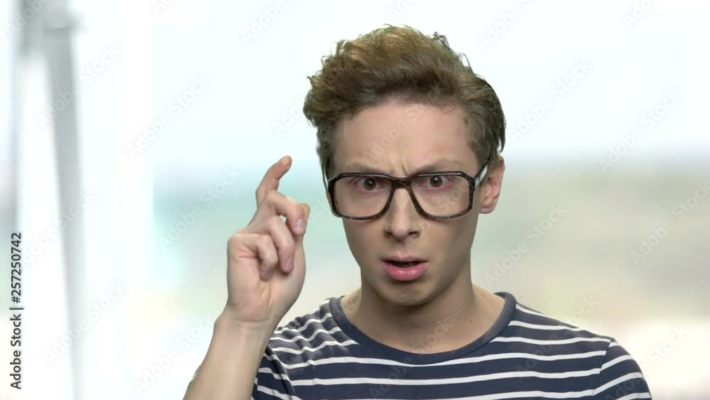 Smart boy in eyeglasses having an idea. Teen boy adjusting his glasses ...