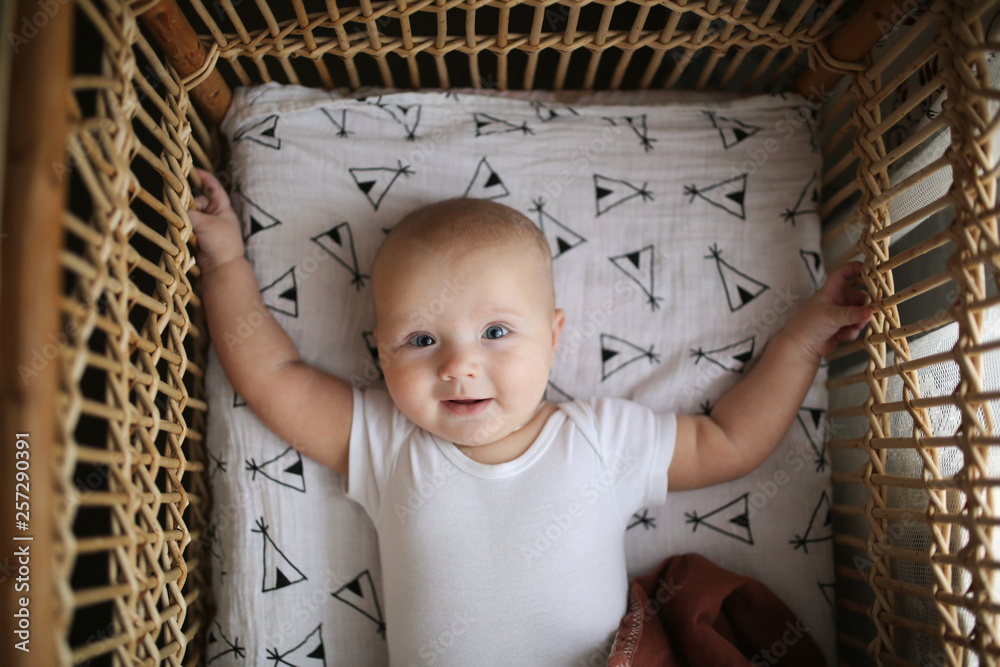 baby lying in wicker crib, top view and emotions Stock Photo | Adobe Stock