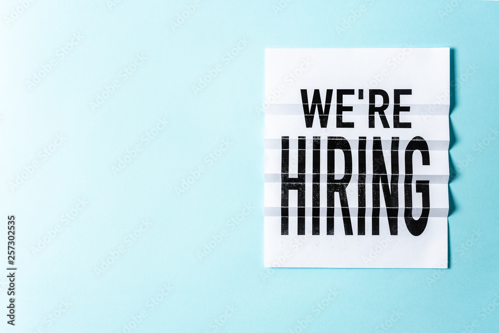Foto de "We're hiring" lettering on textured blue background with blank ...