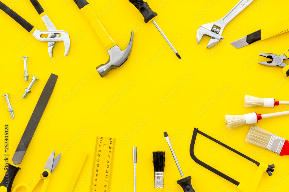 constructor desk with set of building implements and brushes yellow ...