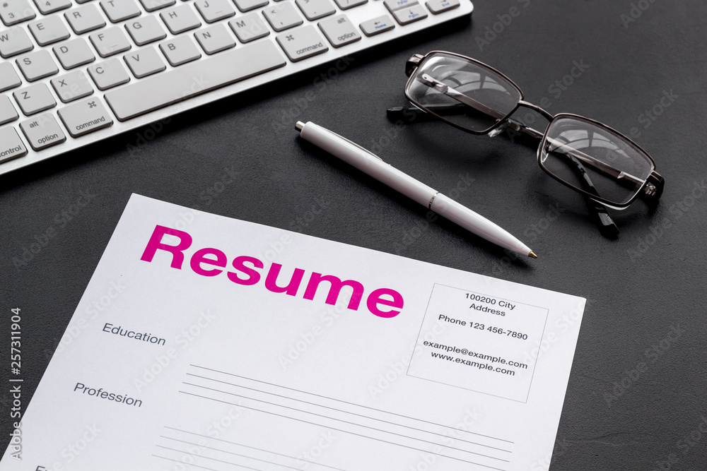 Review resumes of applicants set with keyboard and glasses black work ...