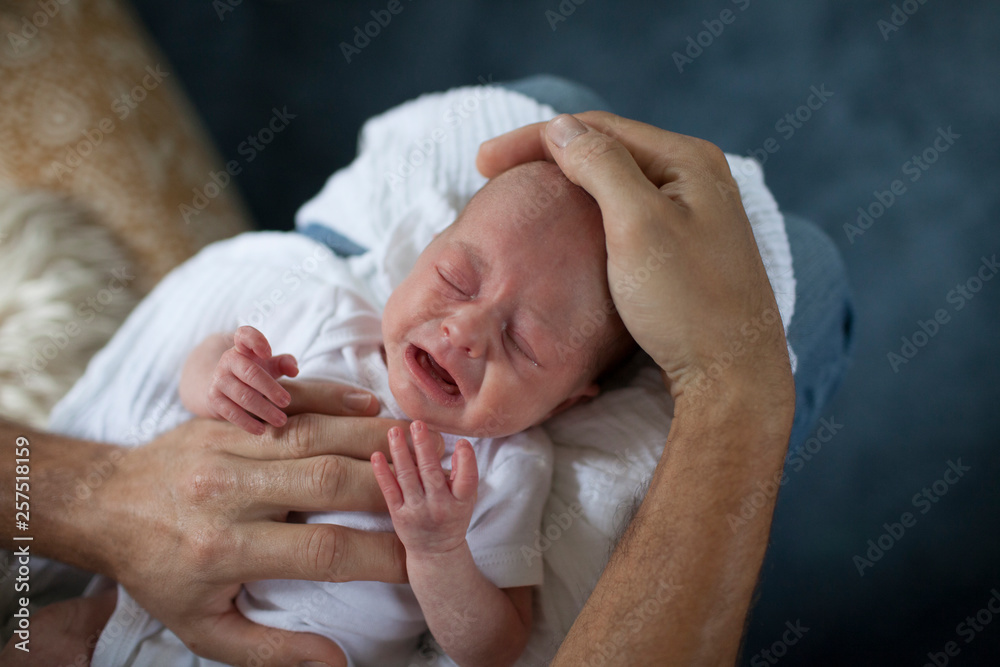 Father comforting crying newborn daughter Stock Photo | Adobe Stock