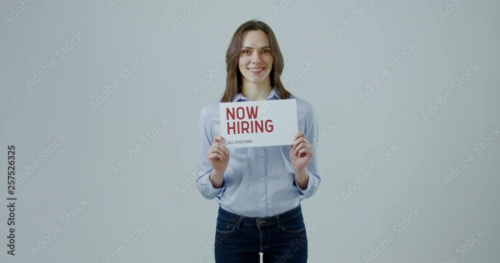 FIXED Attractive Caucasian female HR manager holding recruitment sign ...