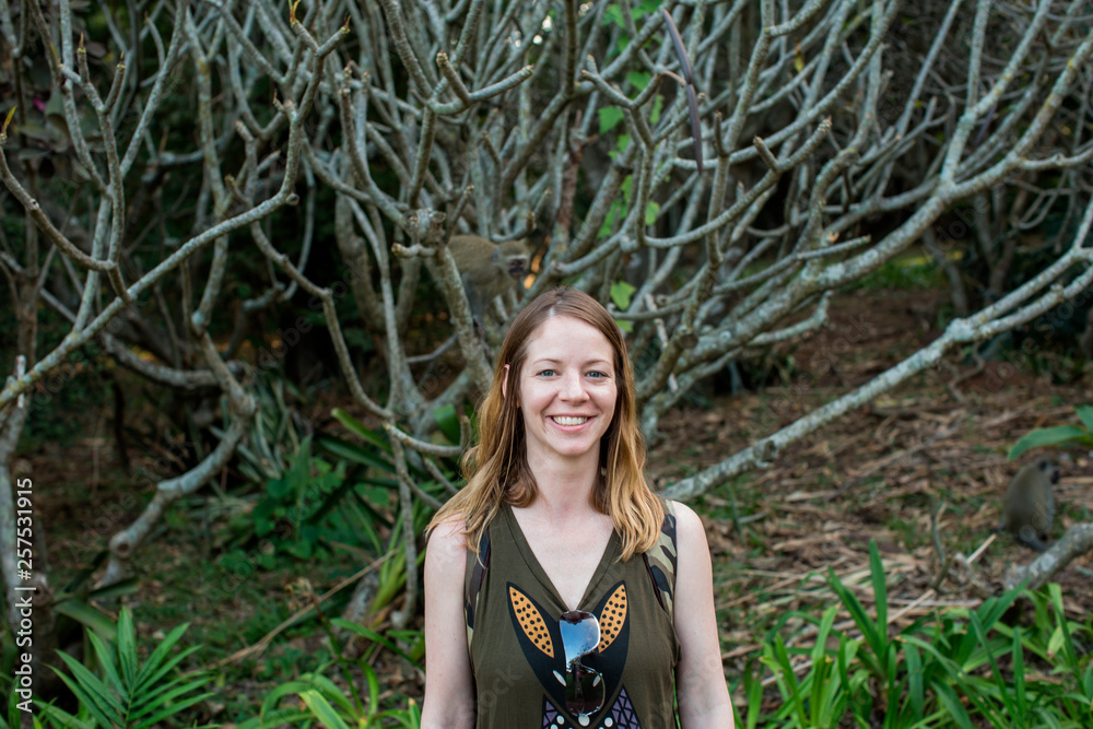Woman standing against Indian banyan tree (Ficus benghalensis) at ...